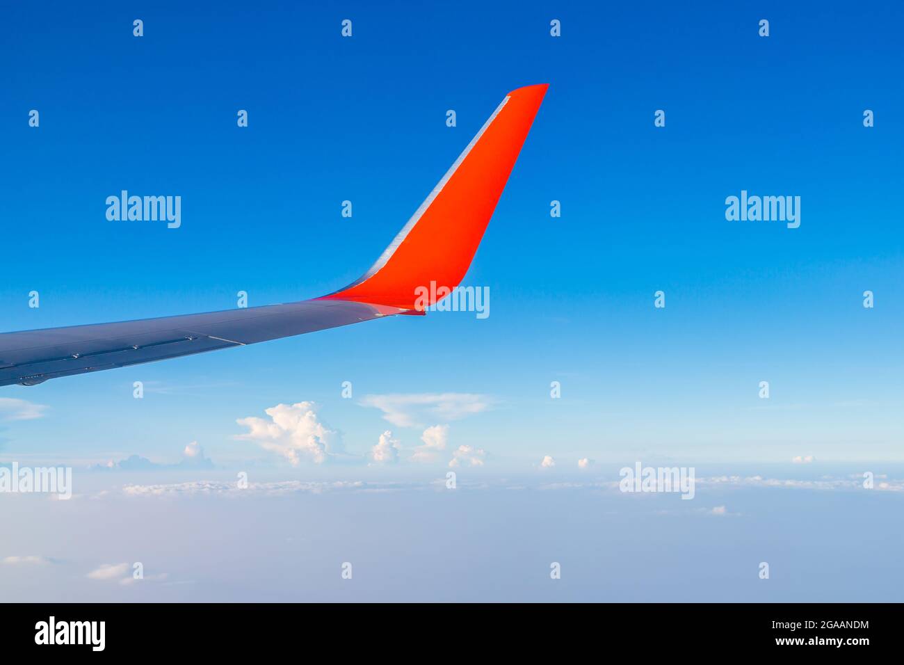 Red Wing of airplane with cloud and bluesky from window Stock Photo - Alamy