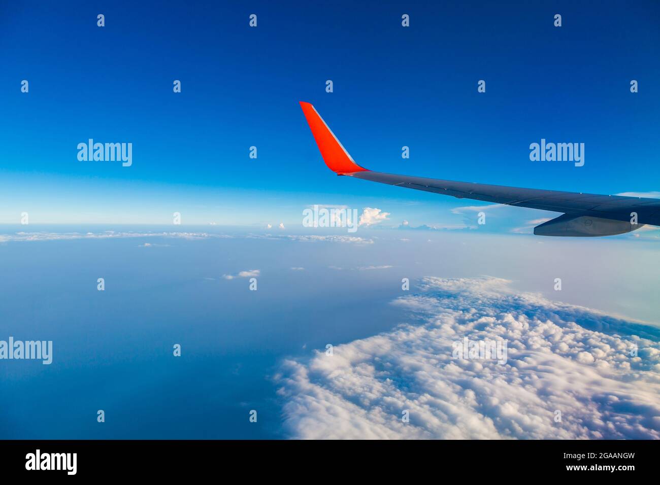 Red Wing of airplane with cloud and bluesky from window Stock Photo - Alamy