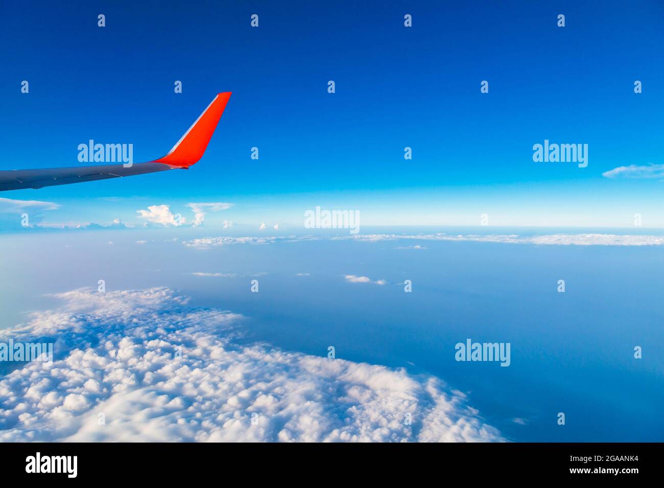 Red Wing of airplane with cloud and bluesky from window Stock Photo - Alamy