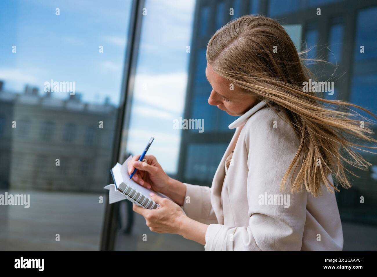 Overworked business woman. Multitasking business woman talking on a ...