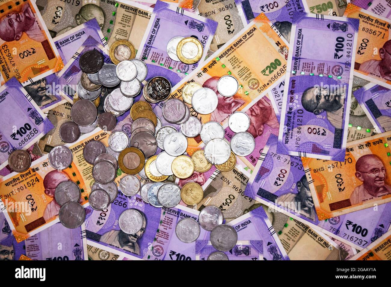 Various Indian paper currency banknotes and coins as a background Stock ...