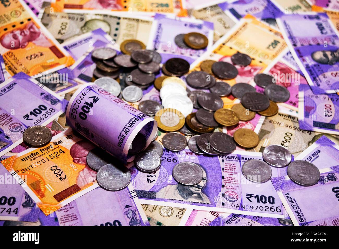 Various Indian paper currency banknotes and roll up one hundred rupees ...