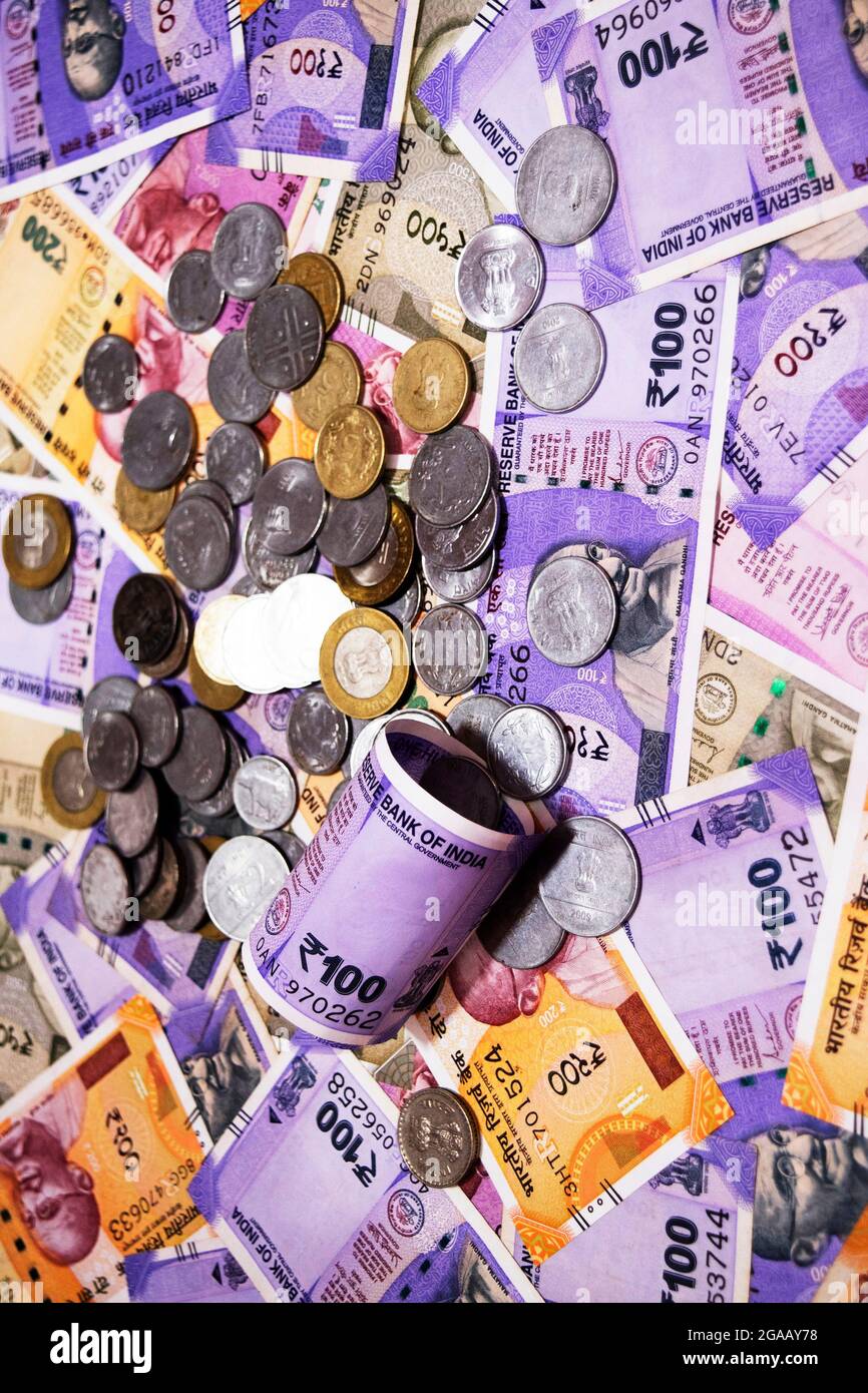 Various Indian paper currency banknotes and roll up one hundred rupees ...