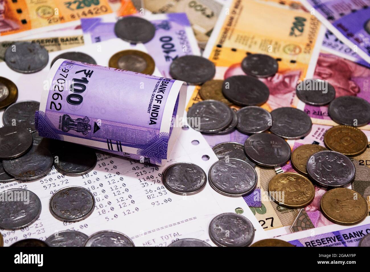 Indian one hundred rupees banknote and coin with a financial bill as a ...