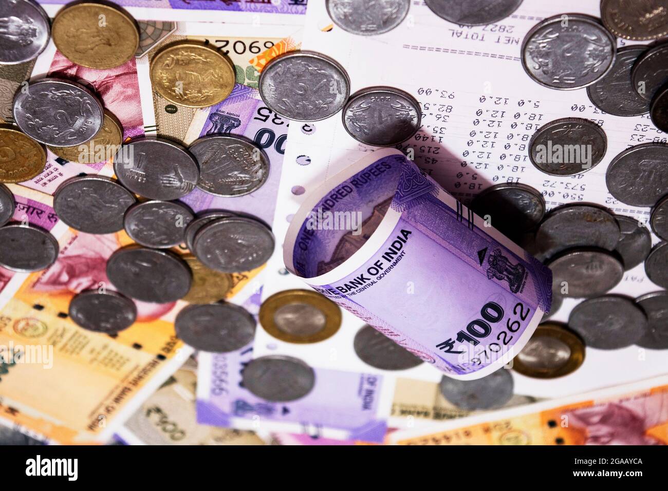 Indian one hundred rupees banknote and coin with a financial bill as a ...