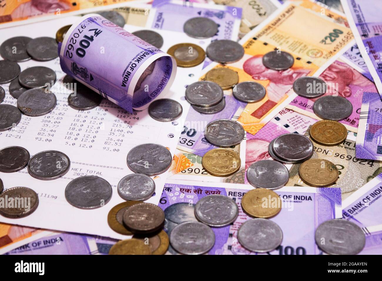 Indian one hundred rupees banknote and coin with a financial bill as a ...