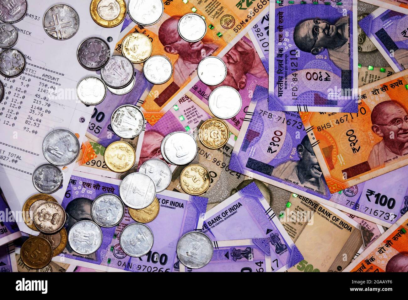 Indian one hundred rupees banknote and coin with a financial bill as a ...