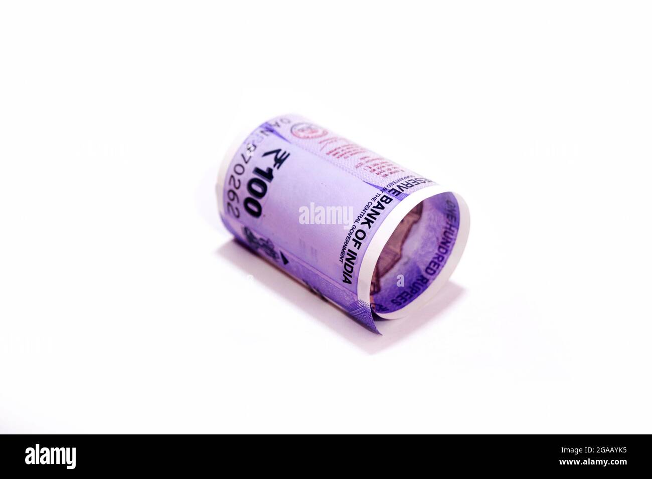 Indian one hundred rupee rolled up banknote isolated on white ...