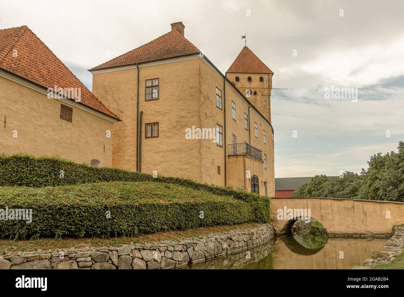 large yellow castle buildings and a bridge over the moat, Tosterup ...
