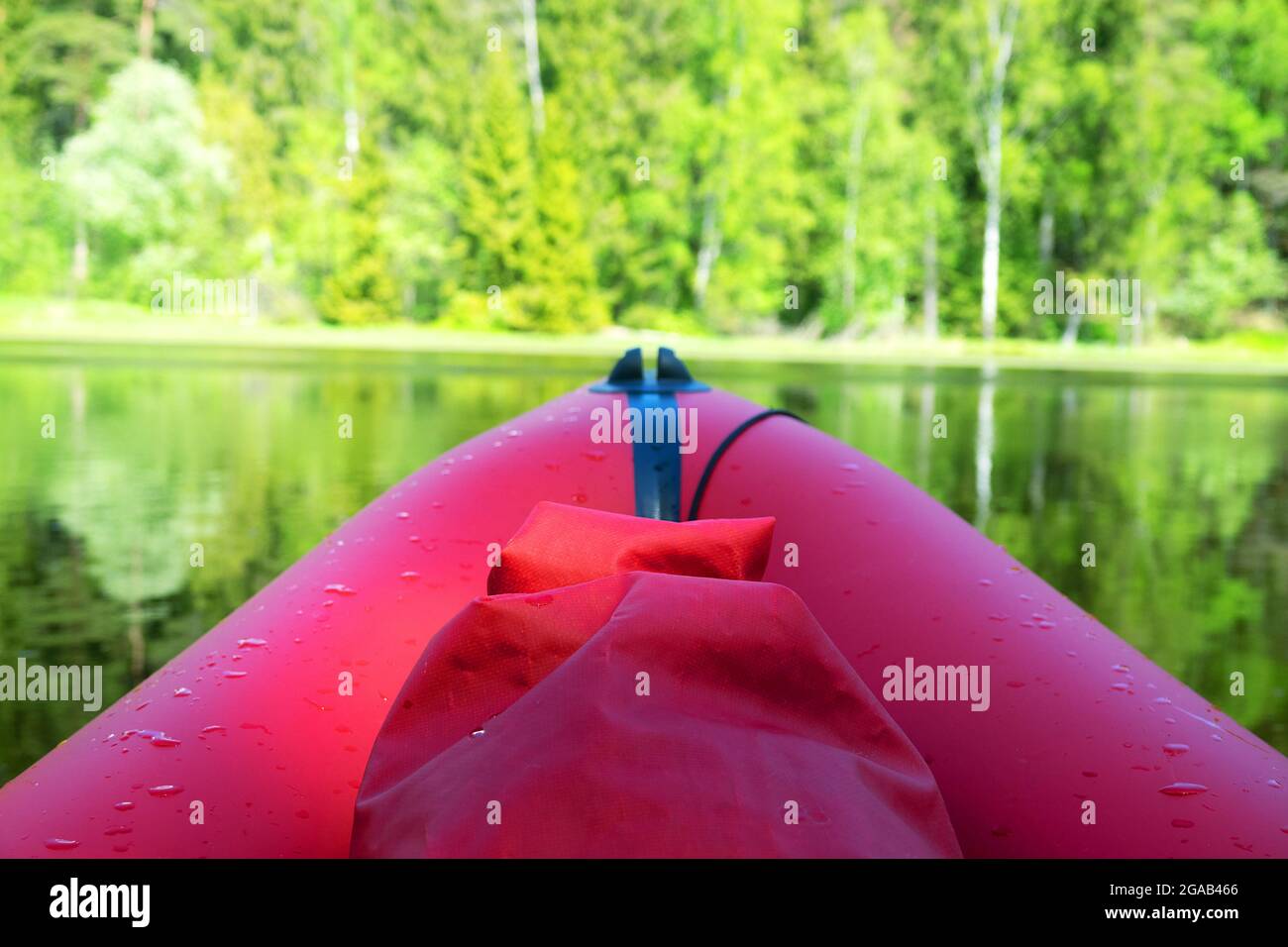 Water-based recreation. Travel on a red inflatable kayak on the small ...