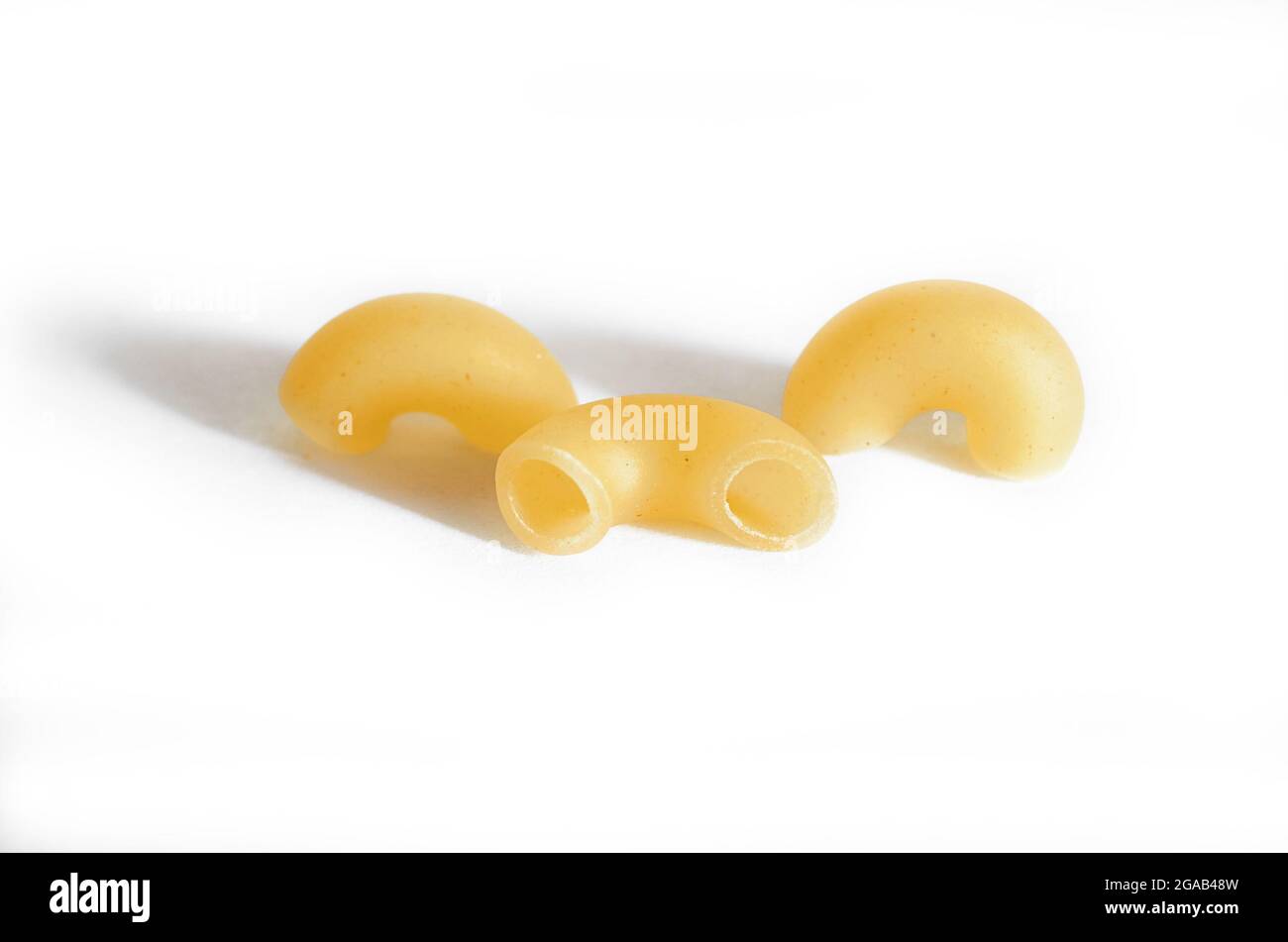 Three macaroni horns isolated on a white background with a shadow Stock ...