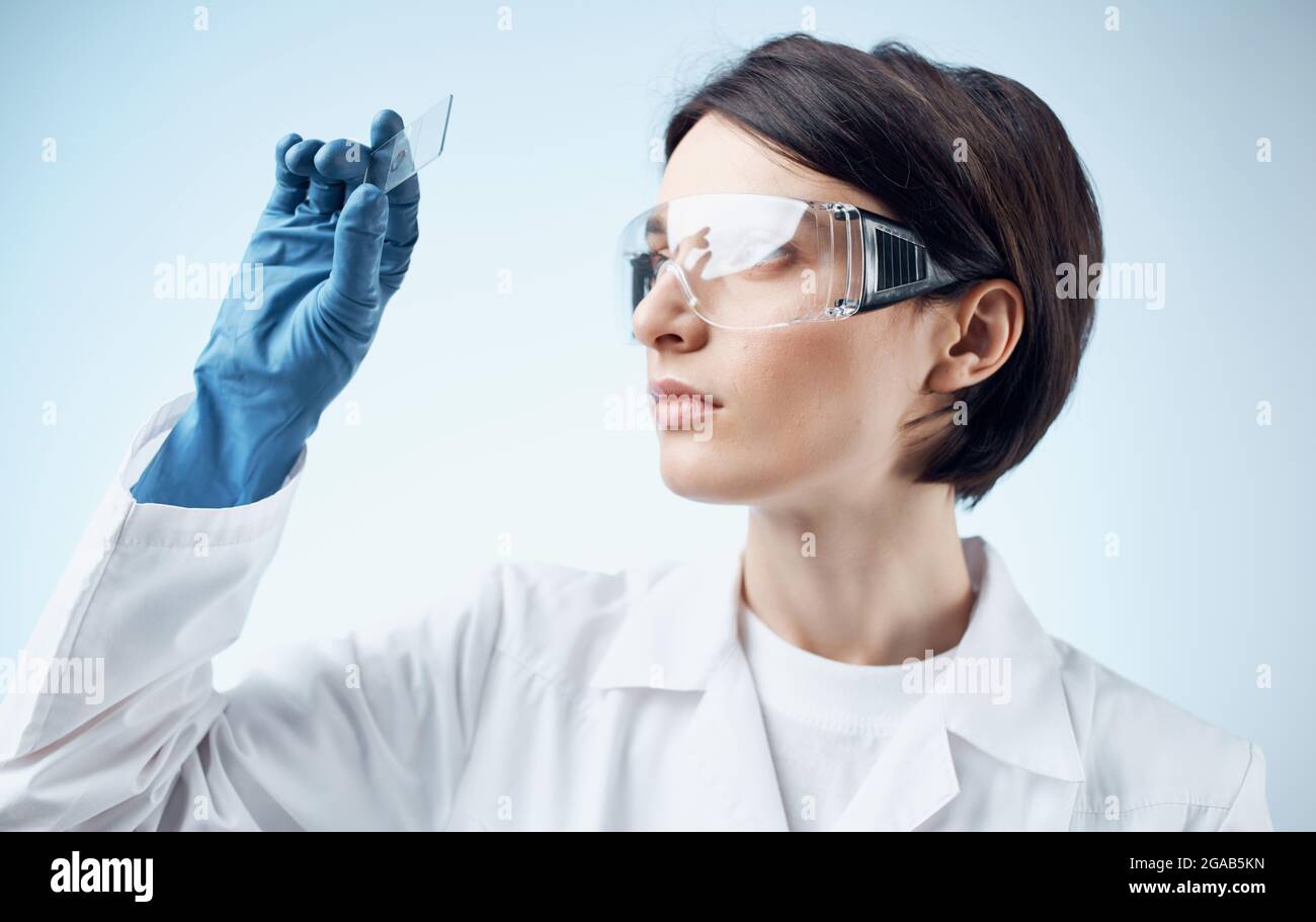 female laboratory assistant in a white coat analysis diagnostics ...