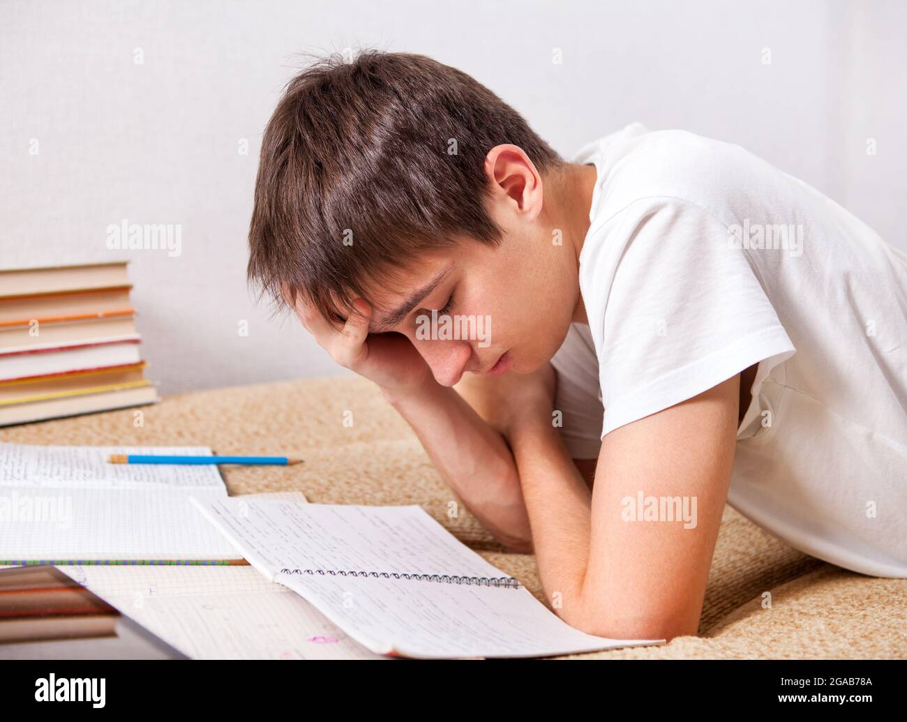 Tired Student doing Homework on the Sofa Stock Photo - Alamy