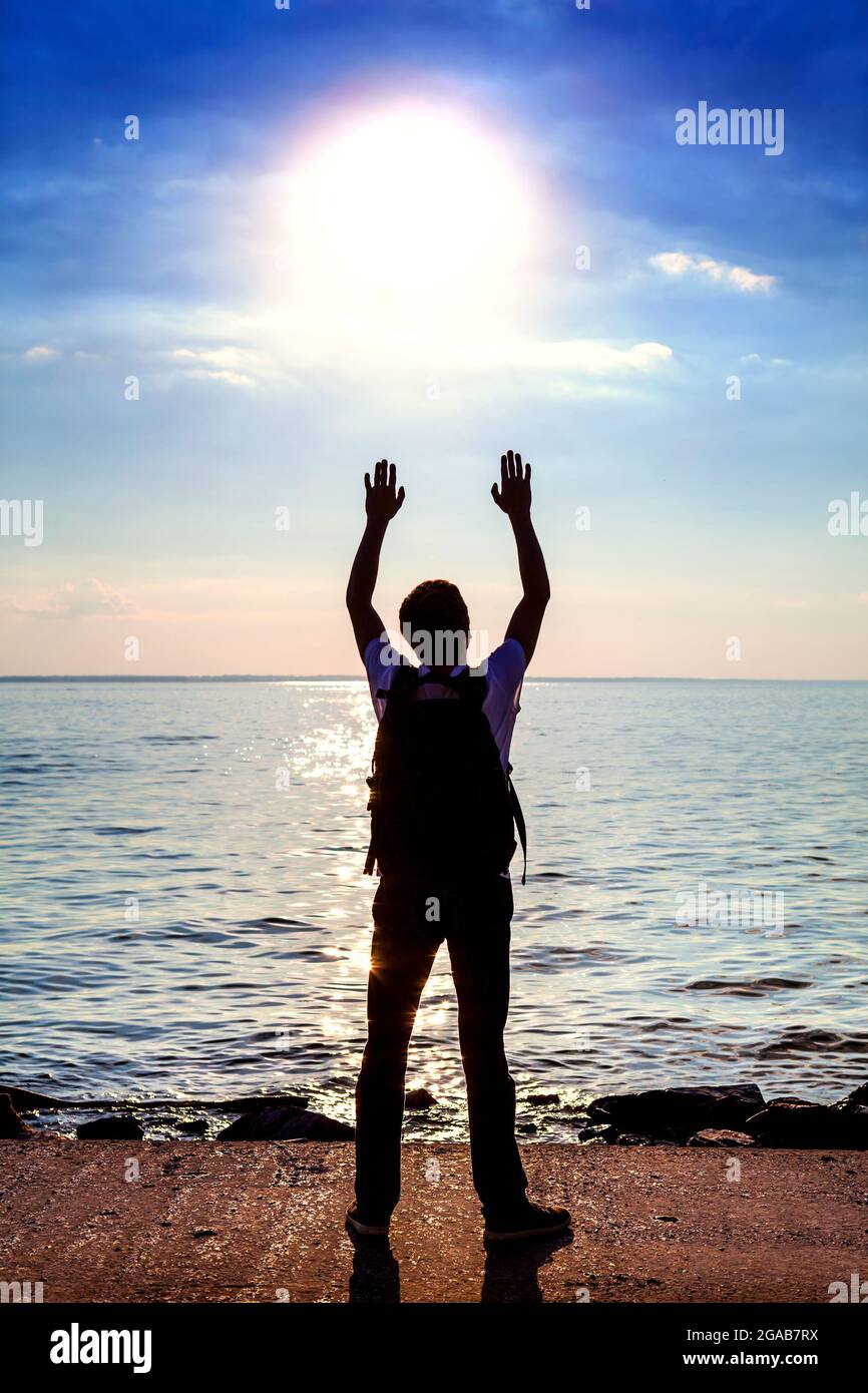Happy Person Silhouette at the Sunset on the Sea Background Stock Photo ...