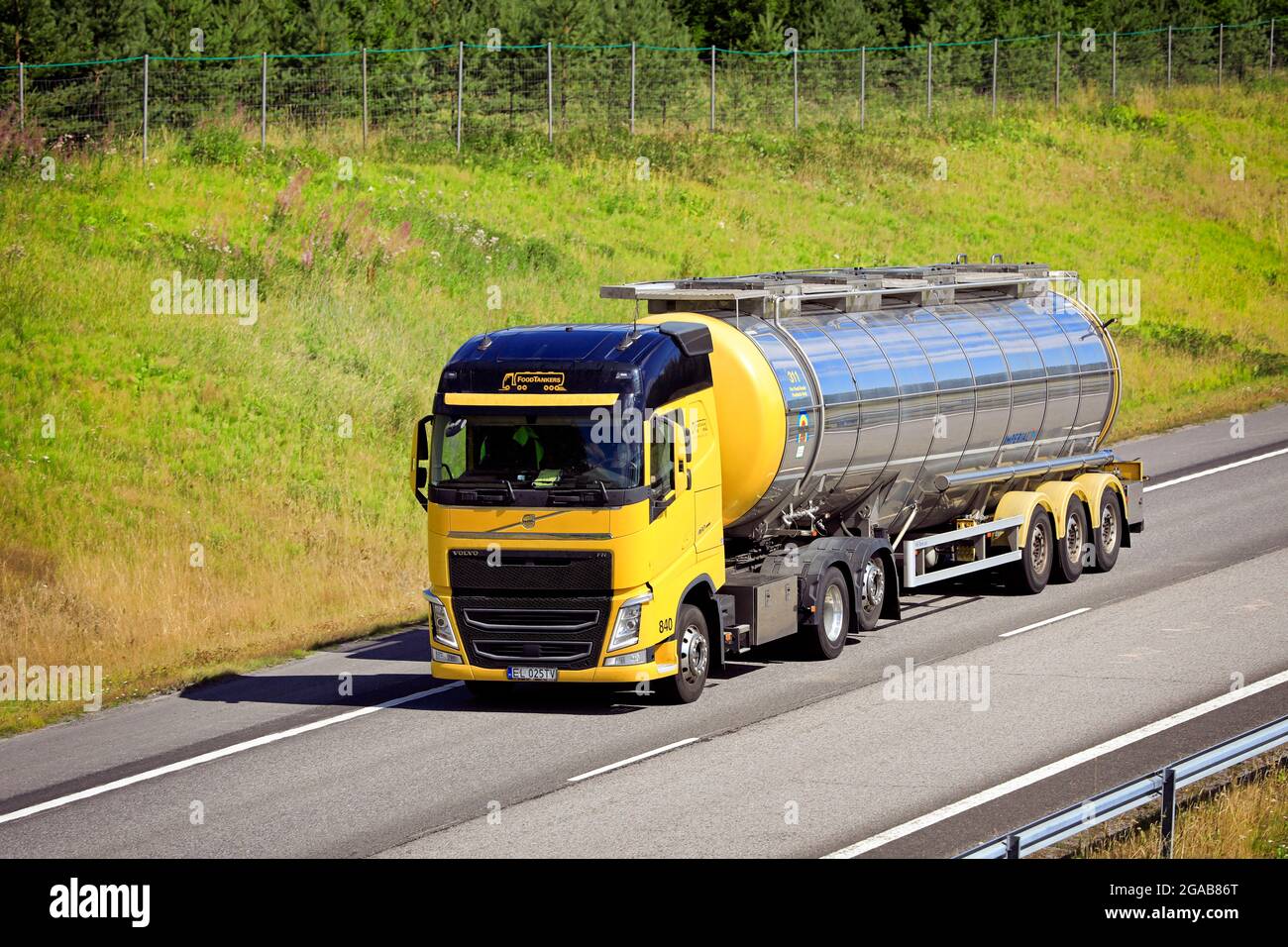Yellow Volvo FH 460 semi tanker for food transport on Motorway E18 ...