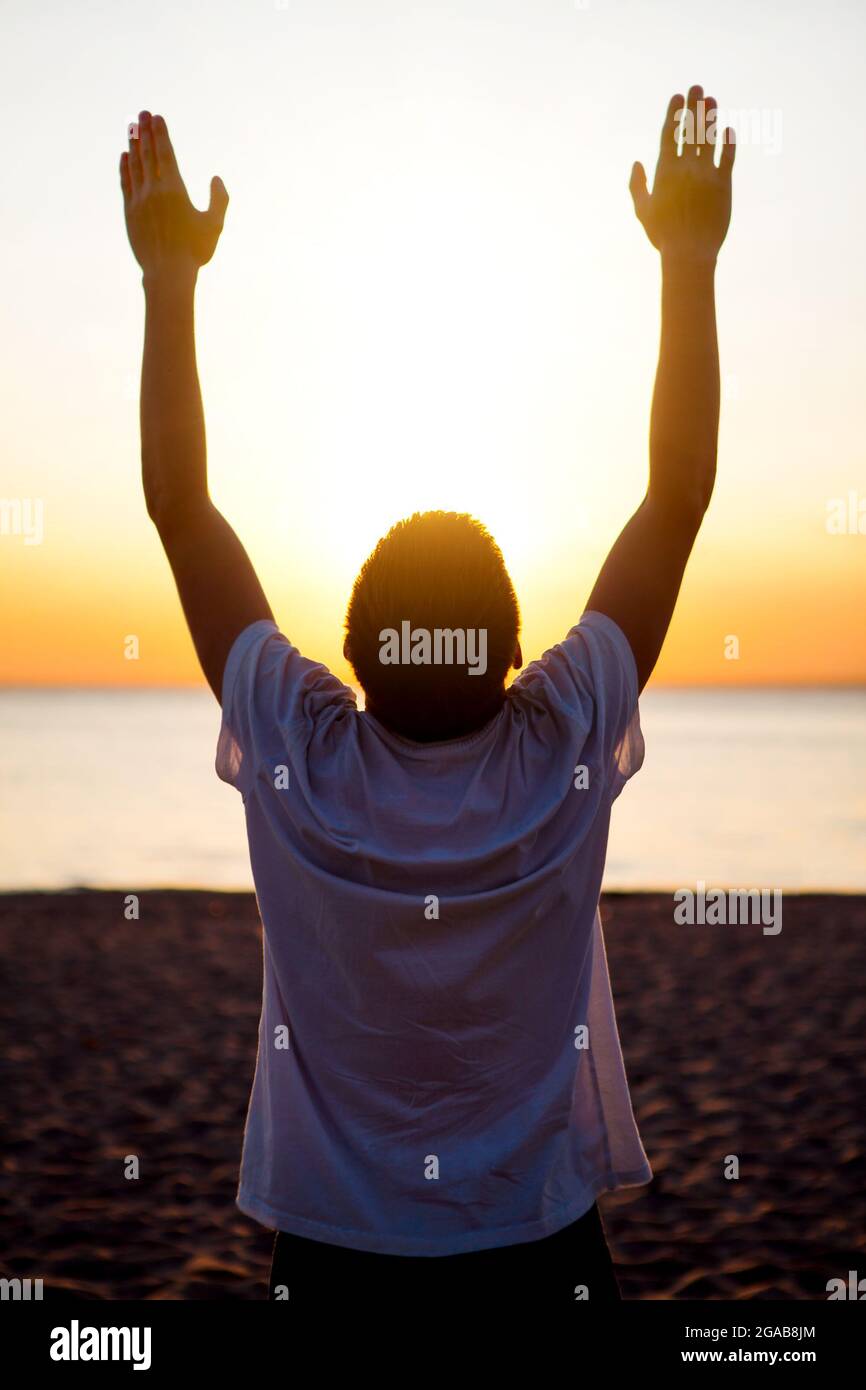 Man Silhouette Praying at the Sunset on the Sea Background Stock Photo ...