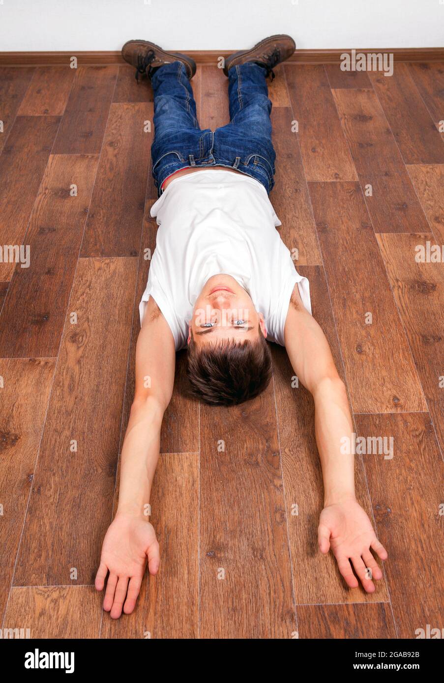 Young Man rest on the Floor in the Room Stock Photo - Alamy