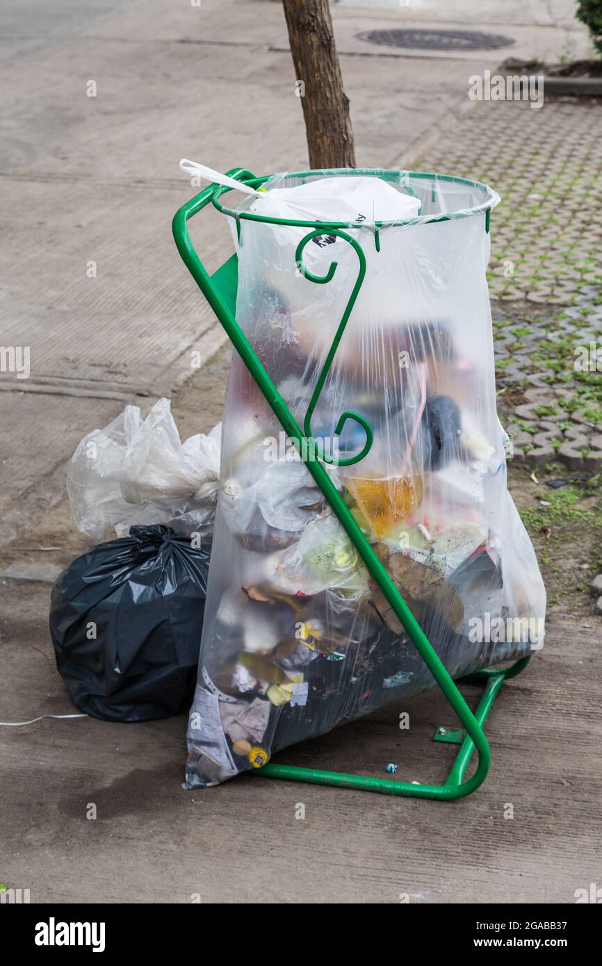 Garbage bags on the sidewalk dirty background Stock Photo - Alamy