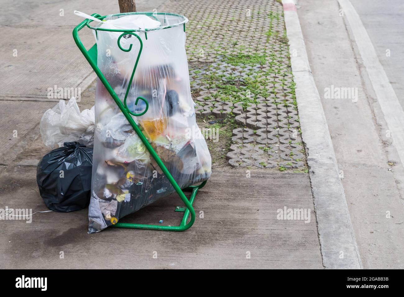 Garbage bags on the sidewalk dirty background Stock Photo - Alamy