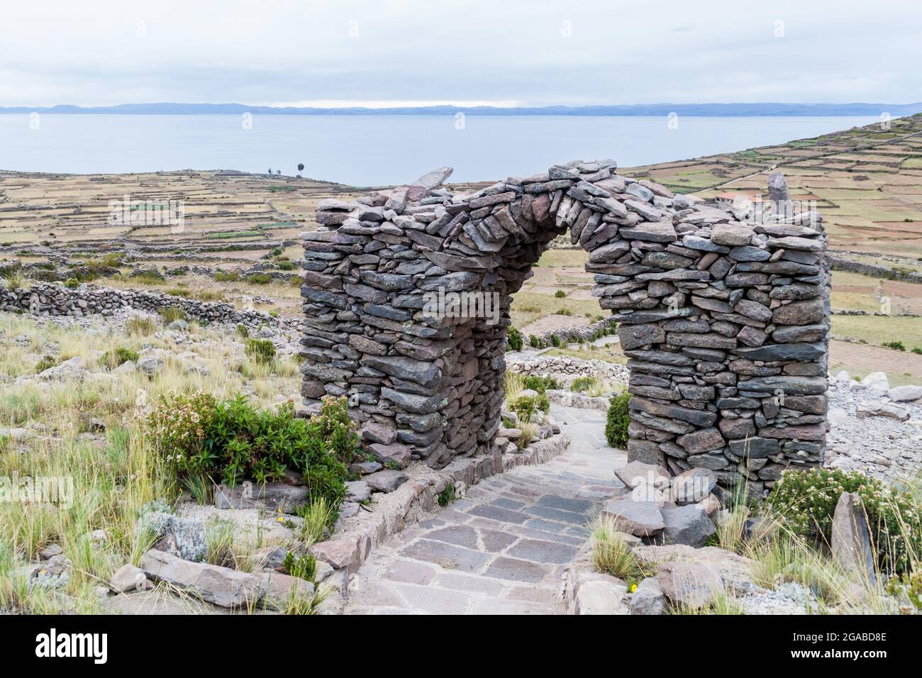Stone arch on Pachatata hill on Amantani island in Titicaca lake, Peru ...