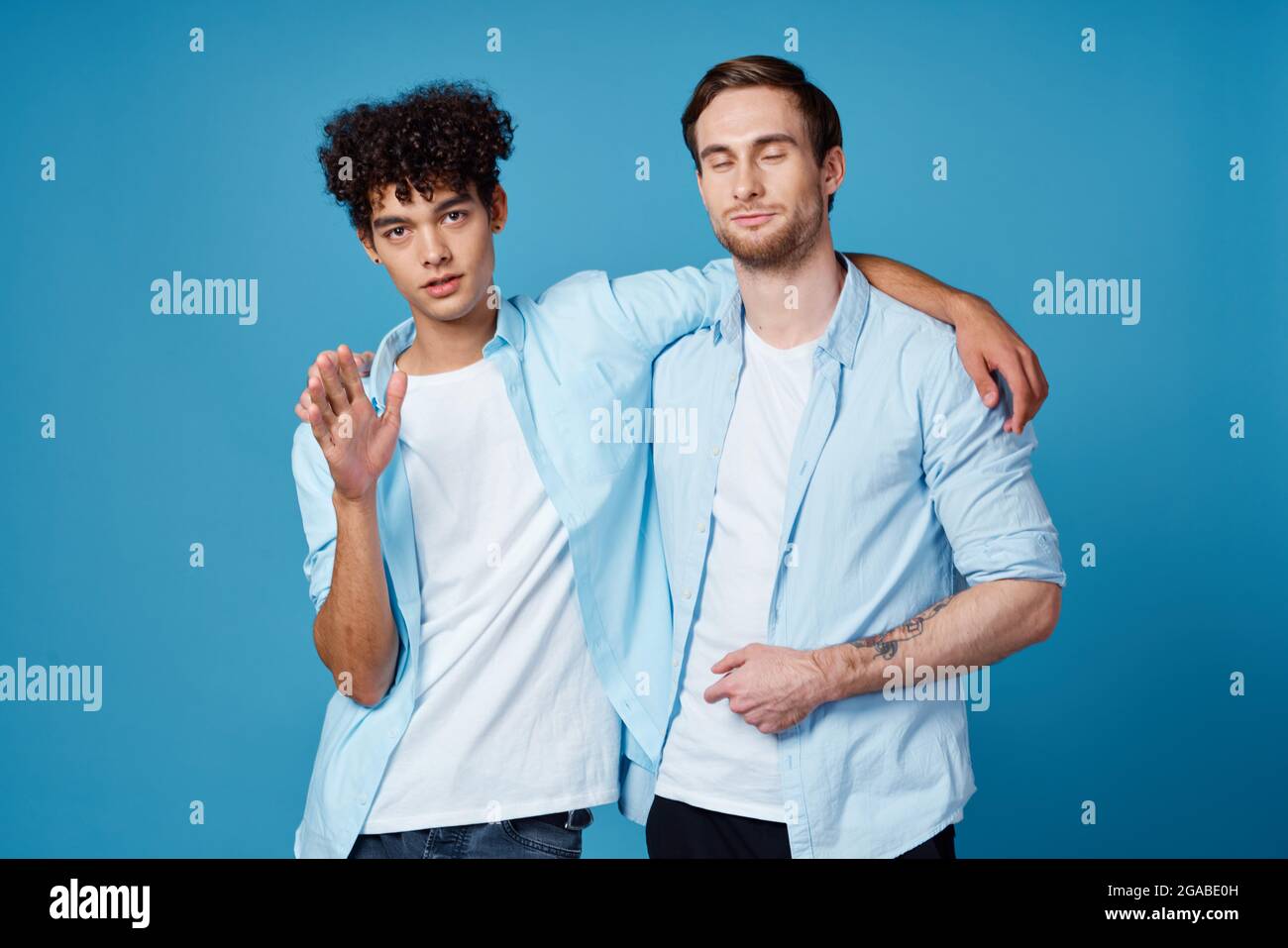 Two cheerful friends stand side by side communication lifestyle Stock ...