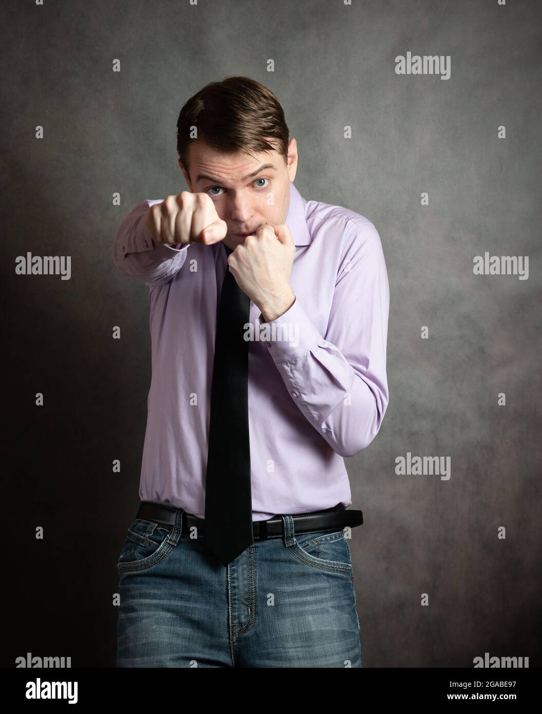 Portrait of angry young man on dark background Stock Photo - Alamy