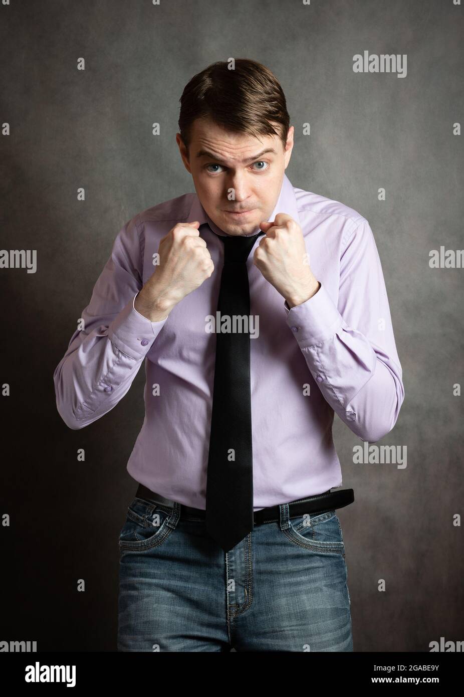 Portrait of angry young man on dark background Stock Photo - Alamy