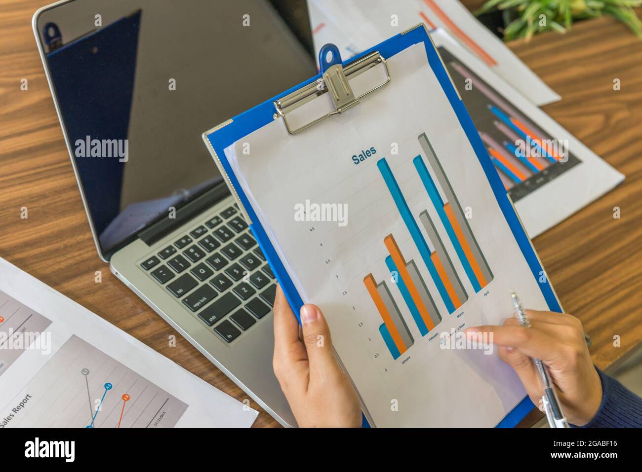 Office woman reading financial number on report Stock Photo - Alamy