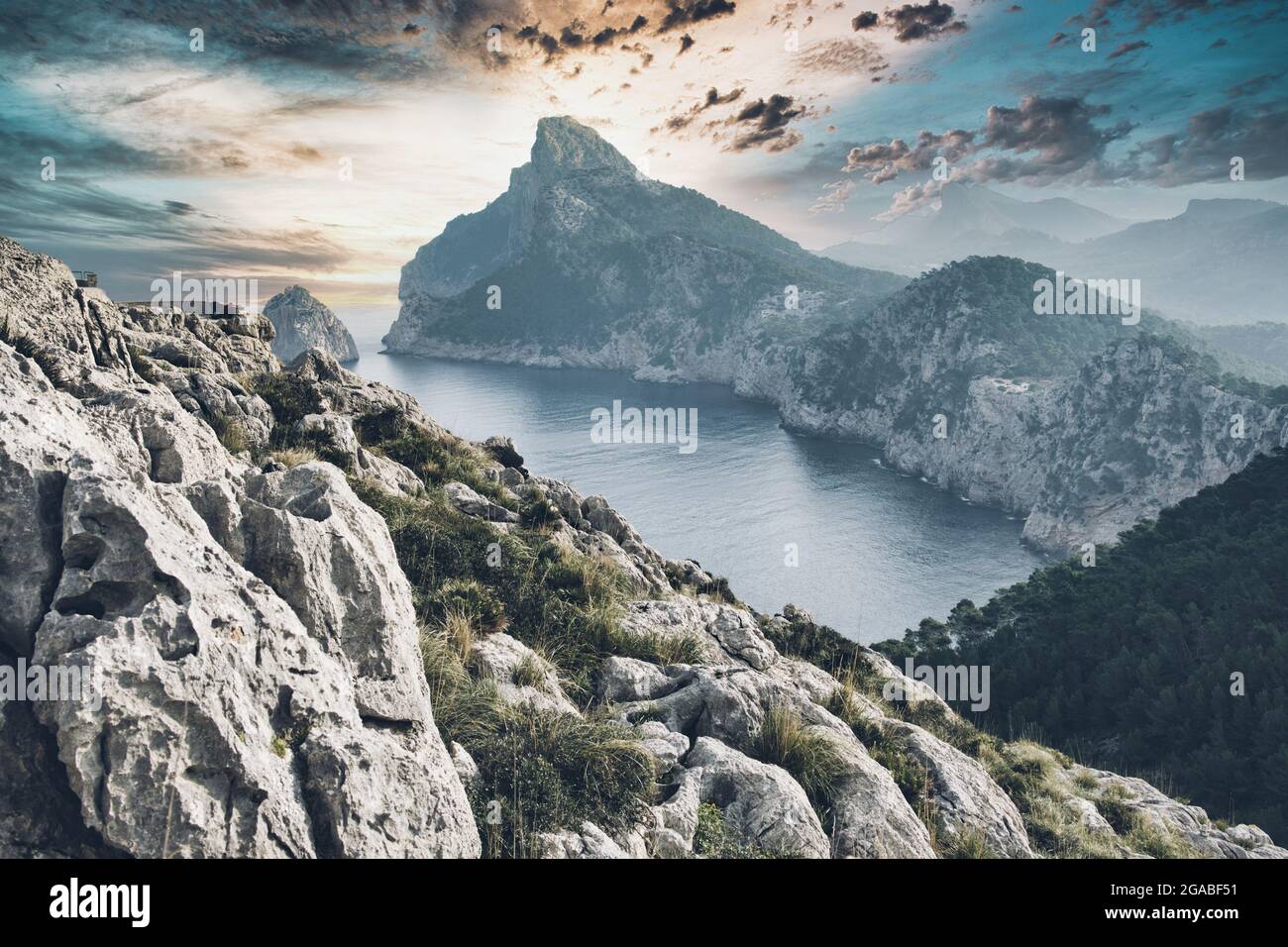 Mesmerizing view of green mountains under red sky at sunset in Mallorca ...