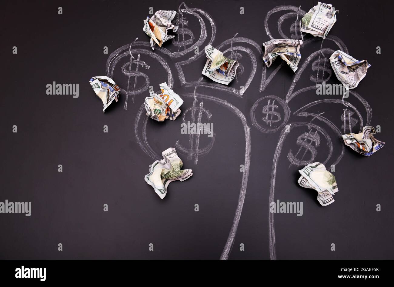 Chalk money tree with crumpled dollars drawing on blackboard background ...