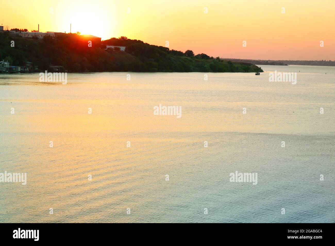 Beautiful view of water and river bank with sunset sky Stock Photo - Alamy