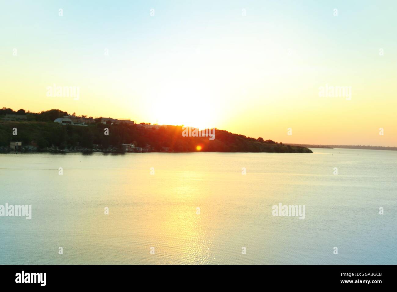 Beautiful view of water and river bank with sunset sky Stock Photo - Alamy