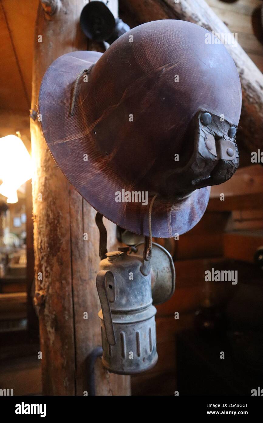 Vertical shot of an old mining helmet hanging with vintage lantern ...