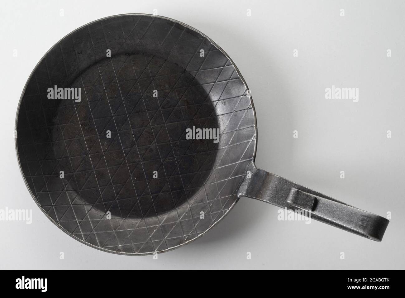 Top view of empty handicraft forged metal frying pan with handle on ...