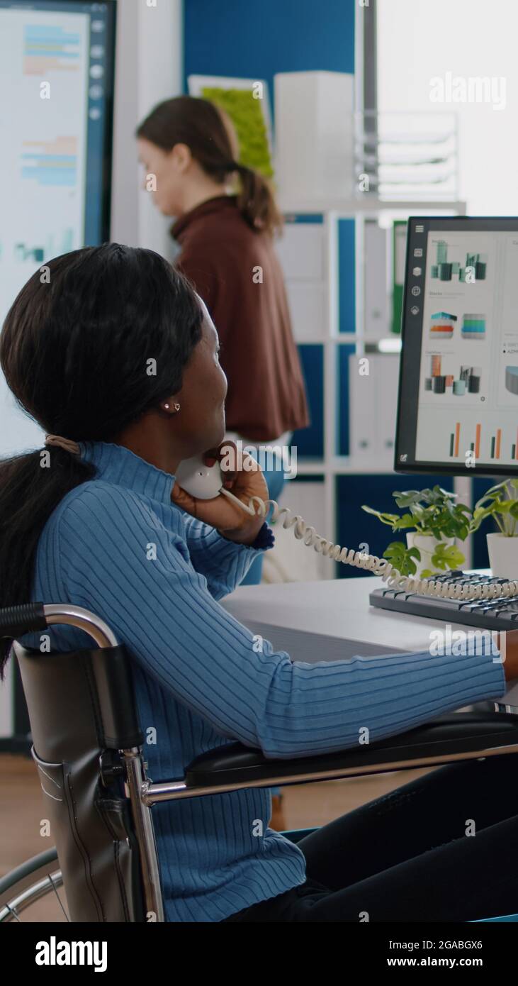 Invalid disabled handicapped african businesswoman sitting in ...