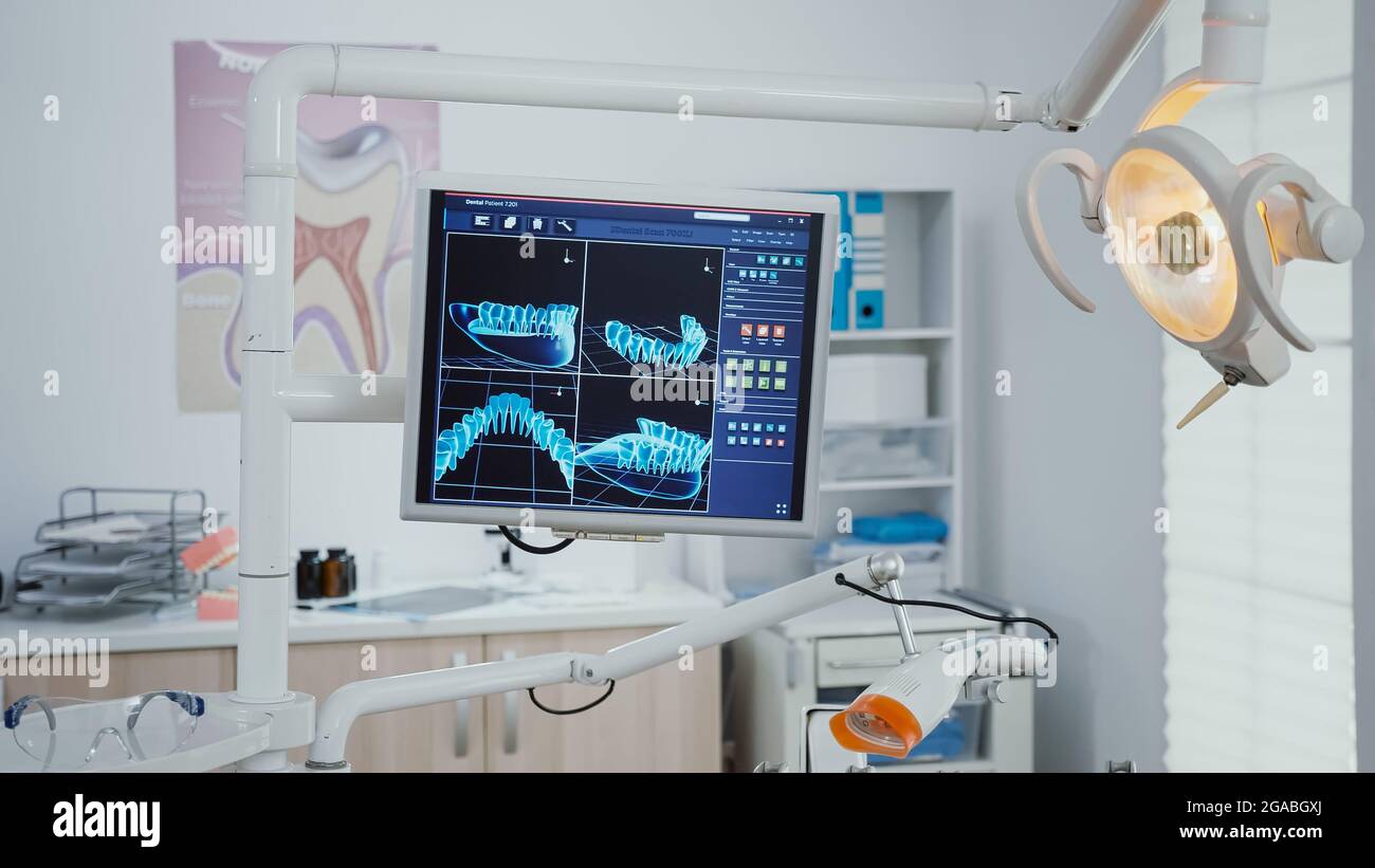 Closeup of monitor with tooth radiography images on it inside empty ...