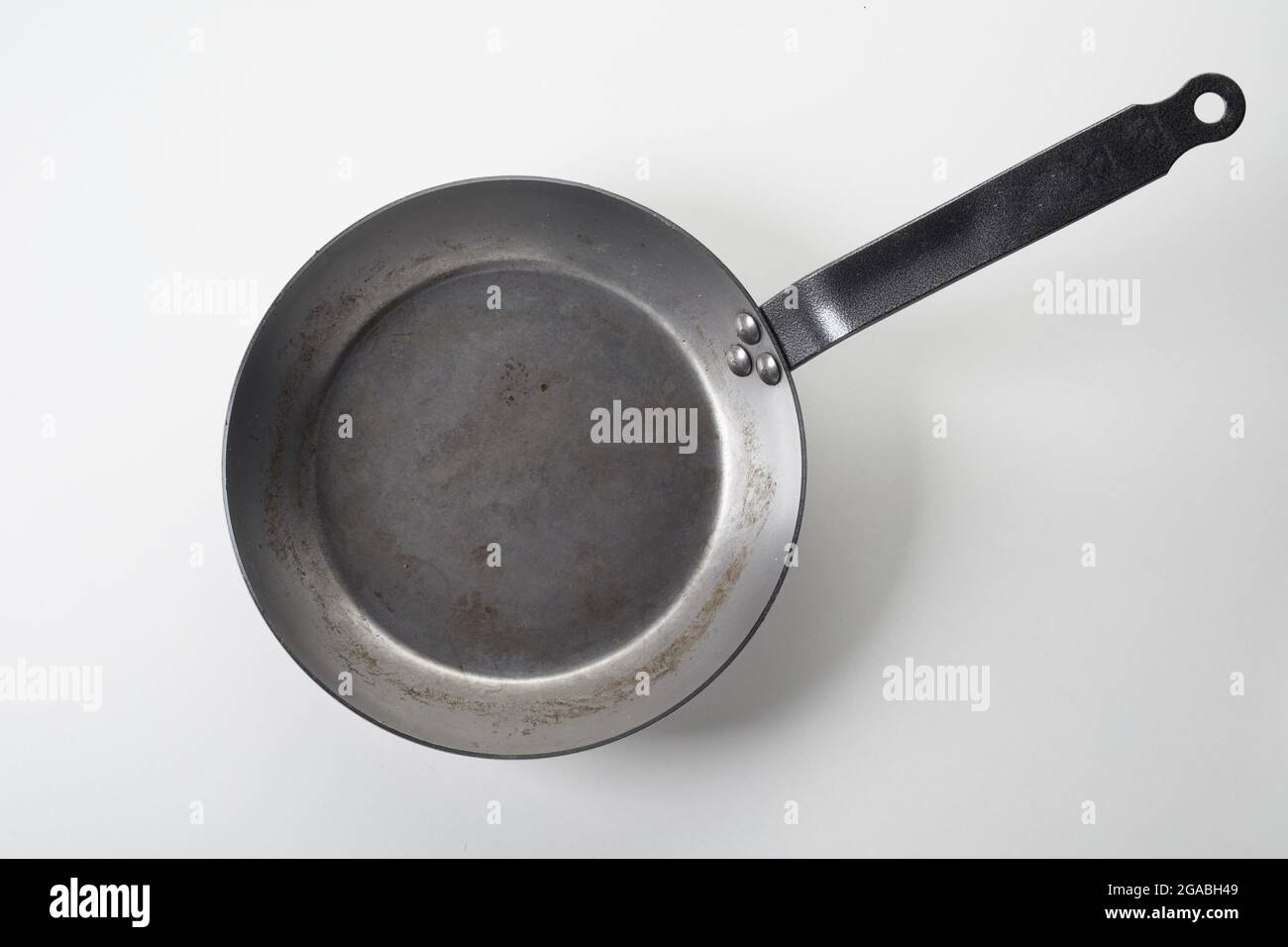 Top view of empty old used aluminum frying pan with metal handle on ...