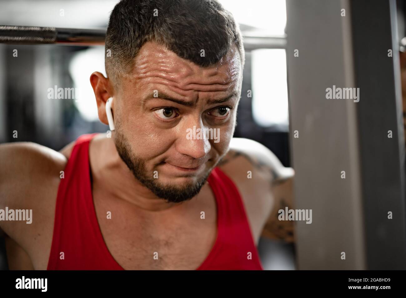Portrait of man bodybuilder in red shirt in gym Stock Photo - Alamy