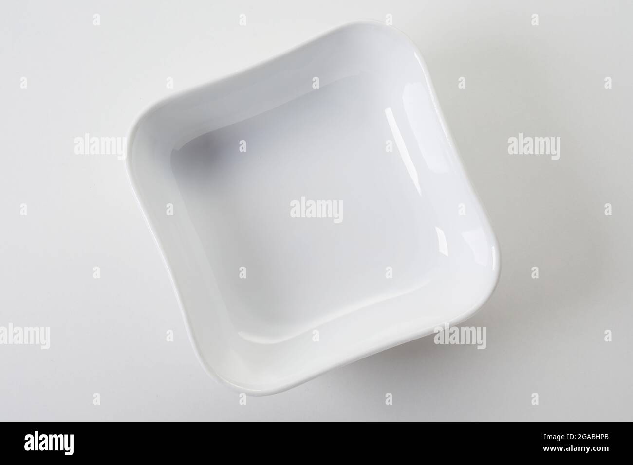 Top view of empty clean square shaped white porcelain salad plate on ...