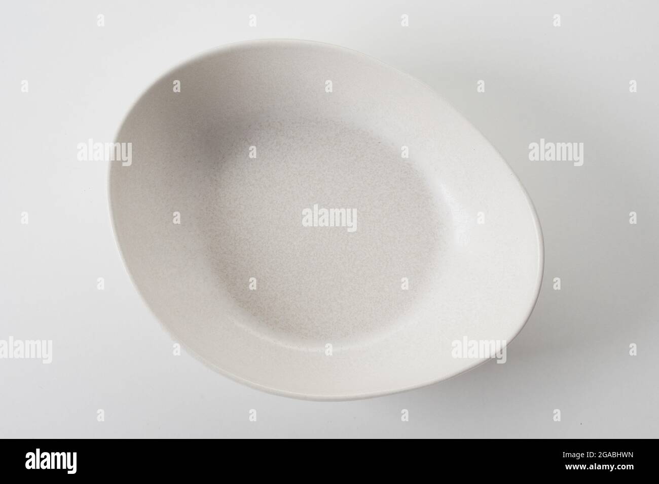 Top view of empty new curve oval shaped white ceramic serving plate on ...