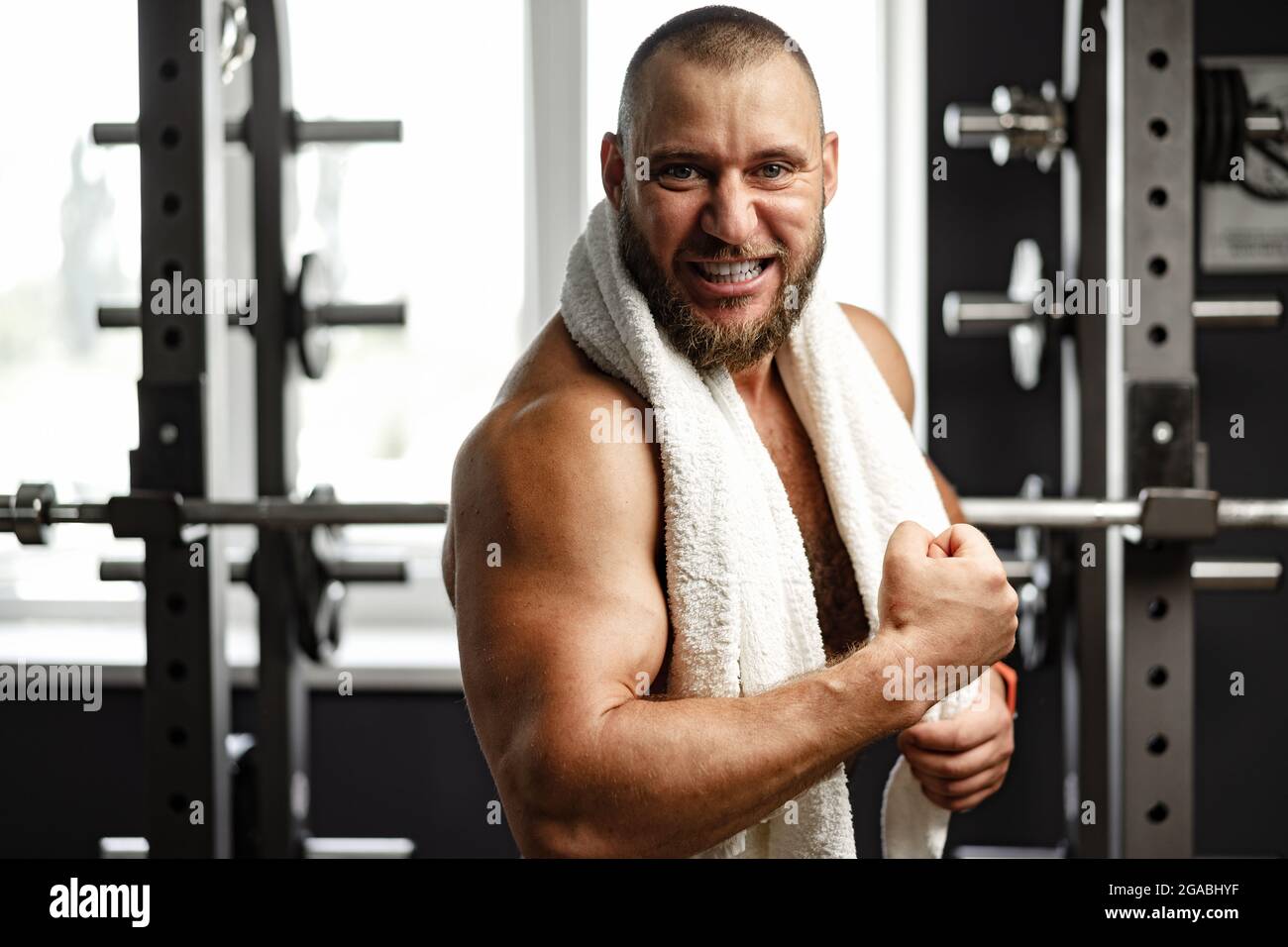 Cheerful smiling man bodybuilder standing in a gym Stock Photo - Alamy