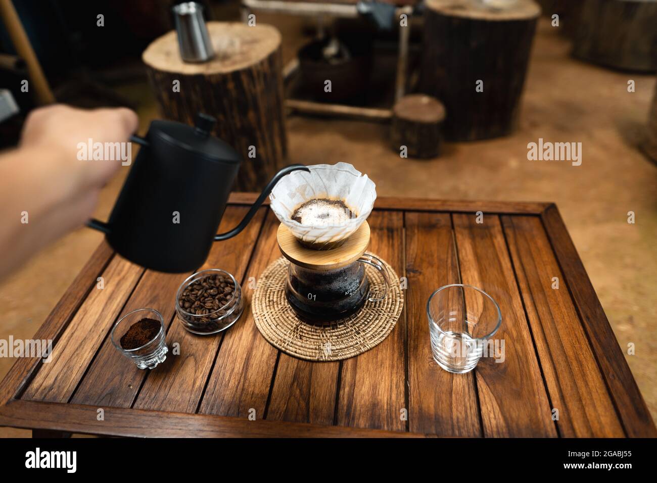Pour hot water into coffee.,drip coffee on a wooden table at home Stock ...