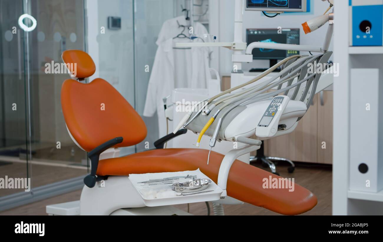 Revealing shot of orthodontist dentistry chair with nobody in, prepared ...