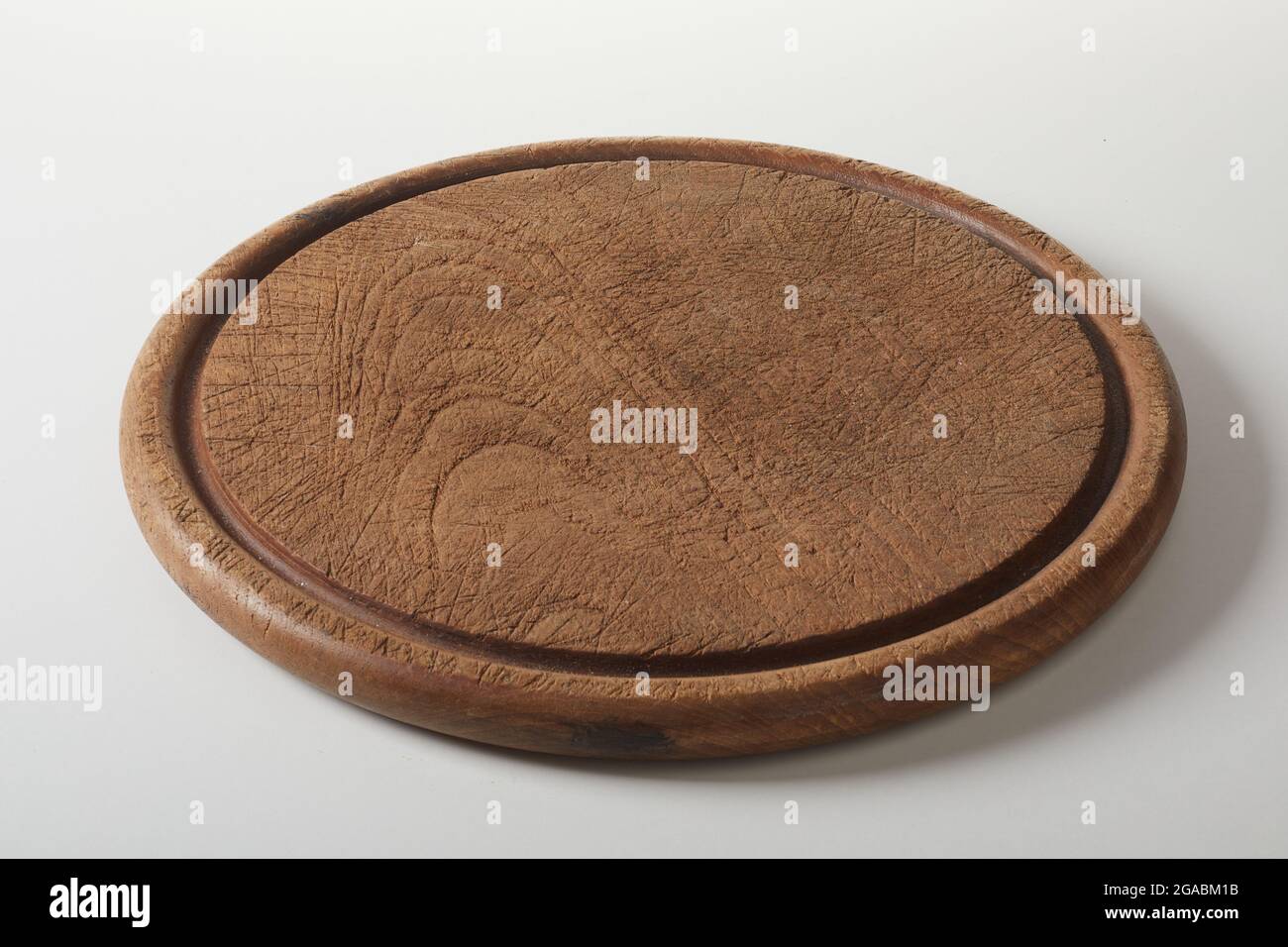 High angle of rustic lumber board of round shape placed on gray ...