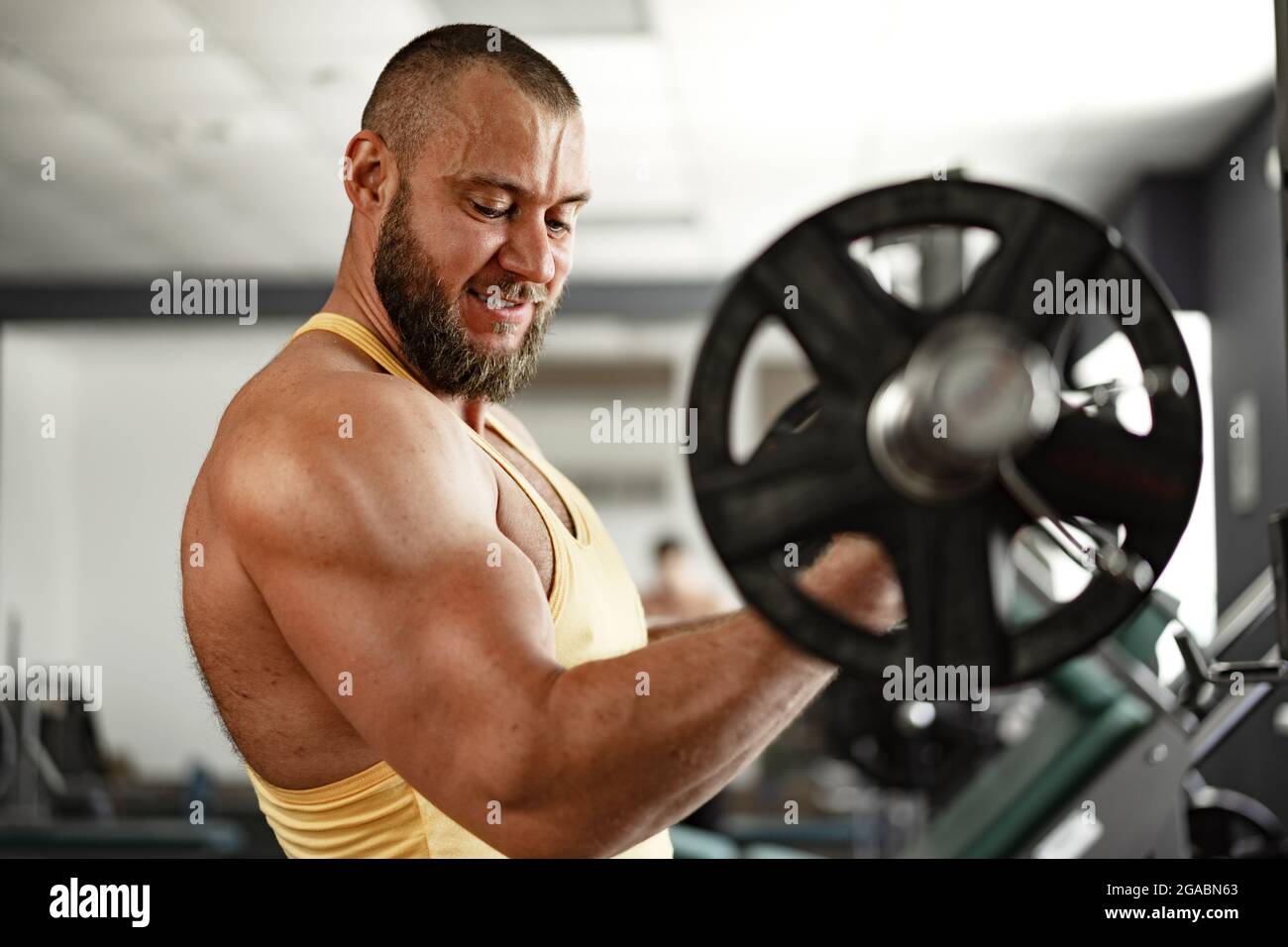 Strong bodybuilder with muscular chest and shoulders in gym Stock Photo ...