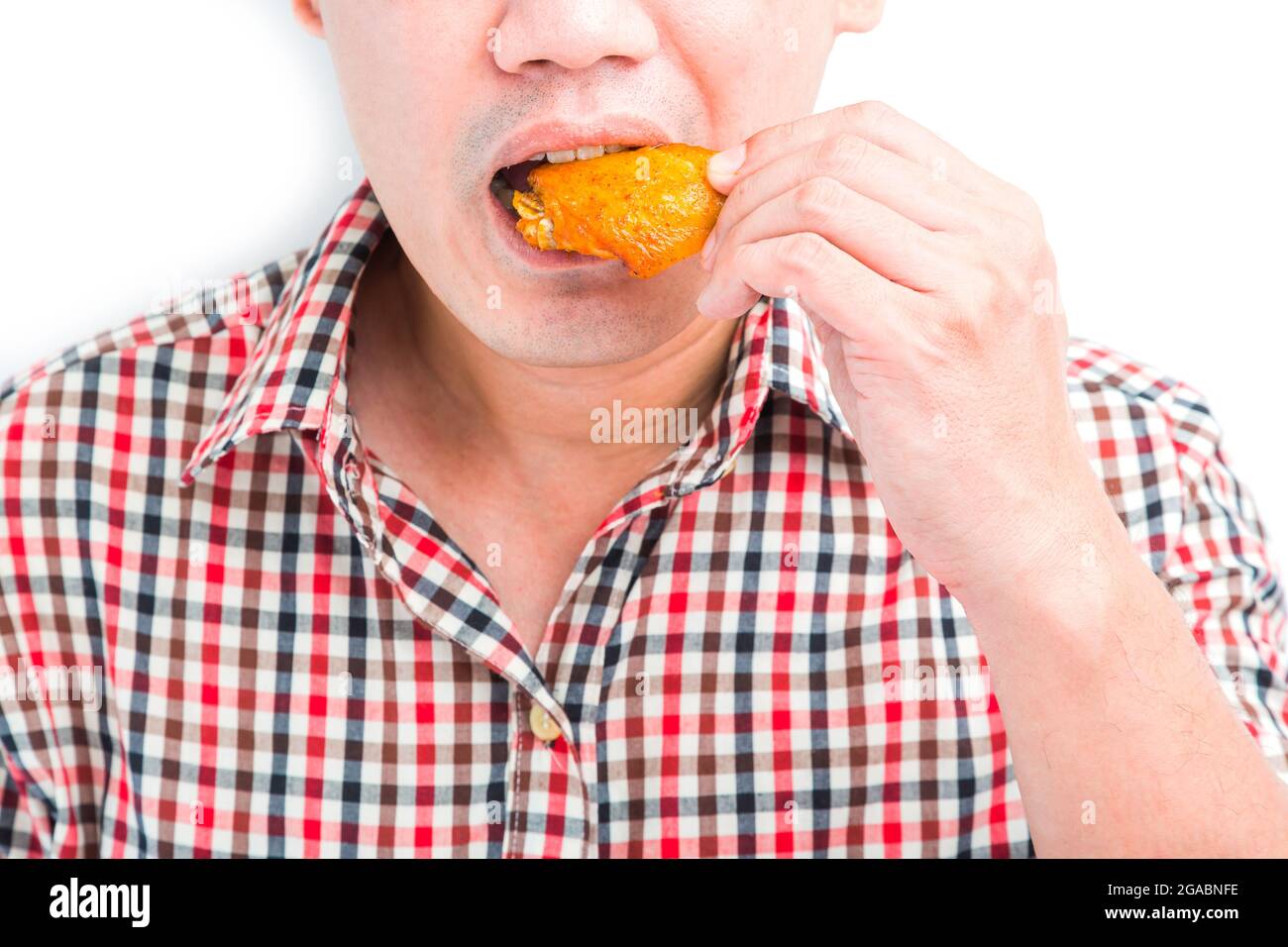 Man eating roasted chicken wings on white background Stock Photo - Alamy