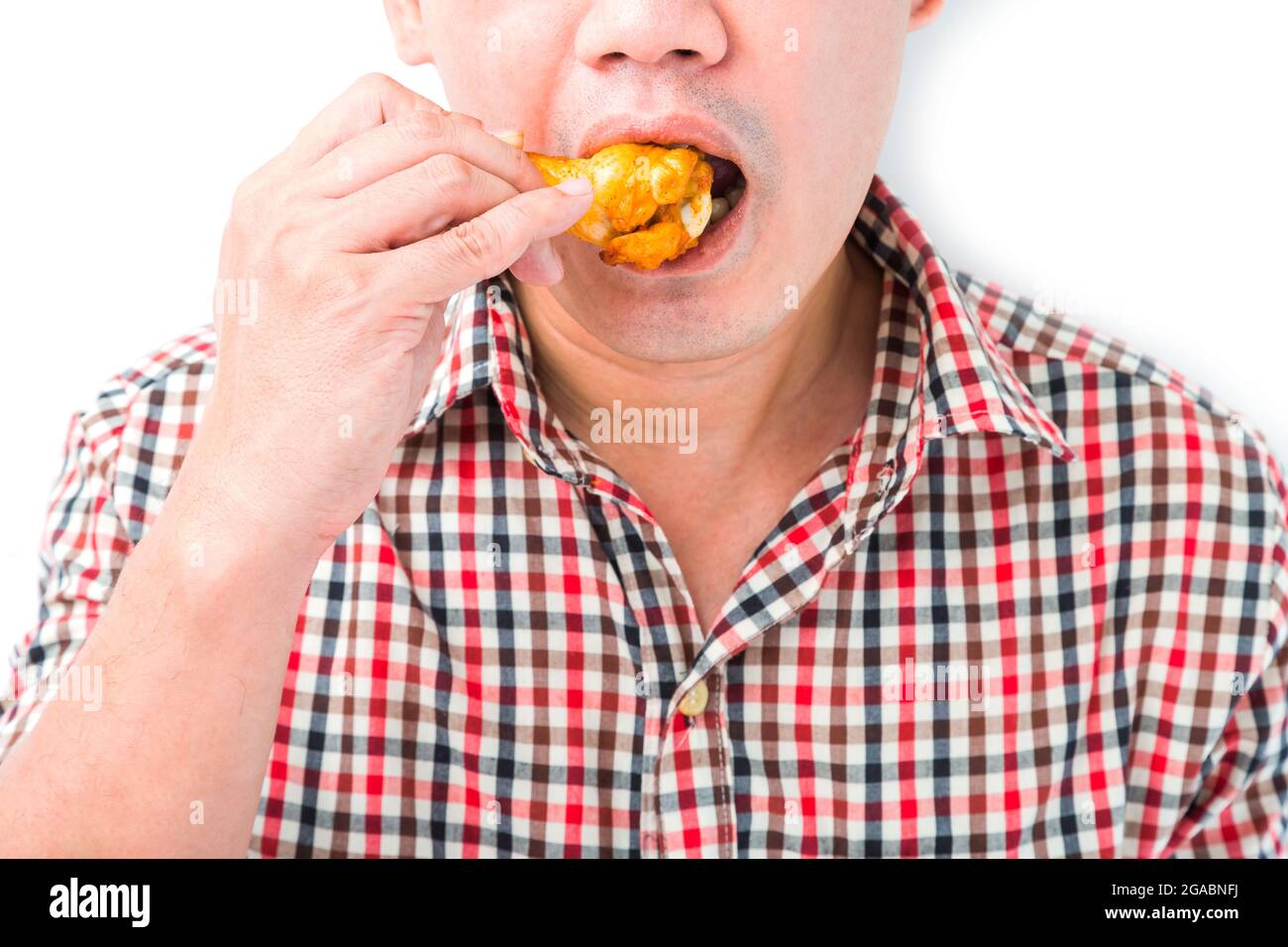 Man eating roasted chicken wings on white background Stock Photo - Alamy