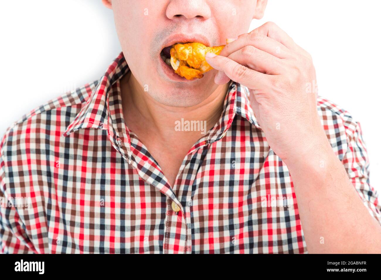 Man eating roasted chicken wings on white background Stock Photo - Alamy