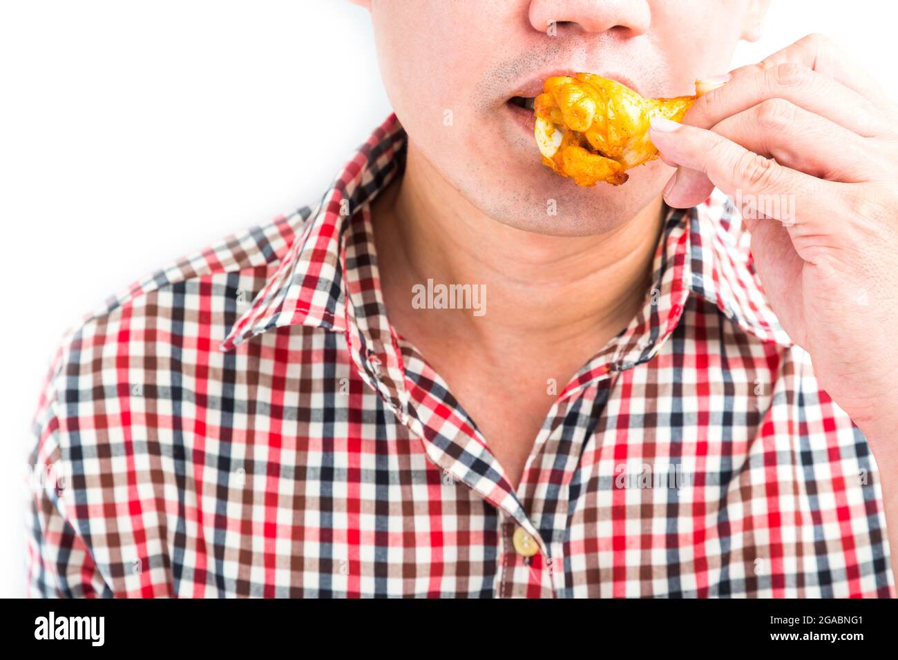 Man eating roasted chicken wings on white background Stock Photo - Alamy