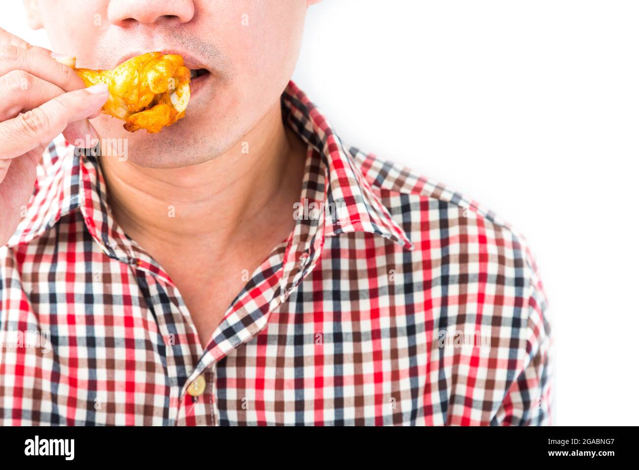 Man eating roasted chicken wings on white background Stock Photo - Alamy